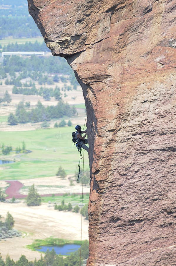 A Rock Climber Hanging from the Side of a Cliff Stock Photo - Image of ...