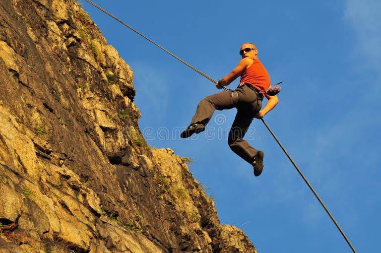 Rock climber jumping stock image. Image of rock, gear - 17605727