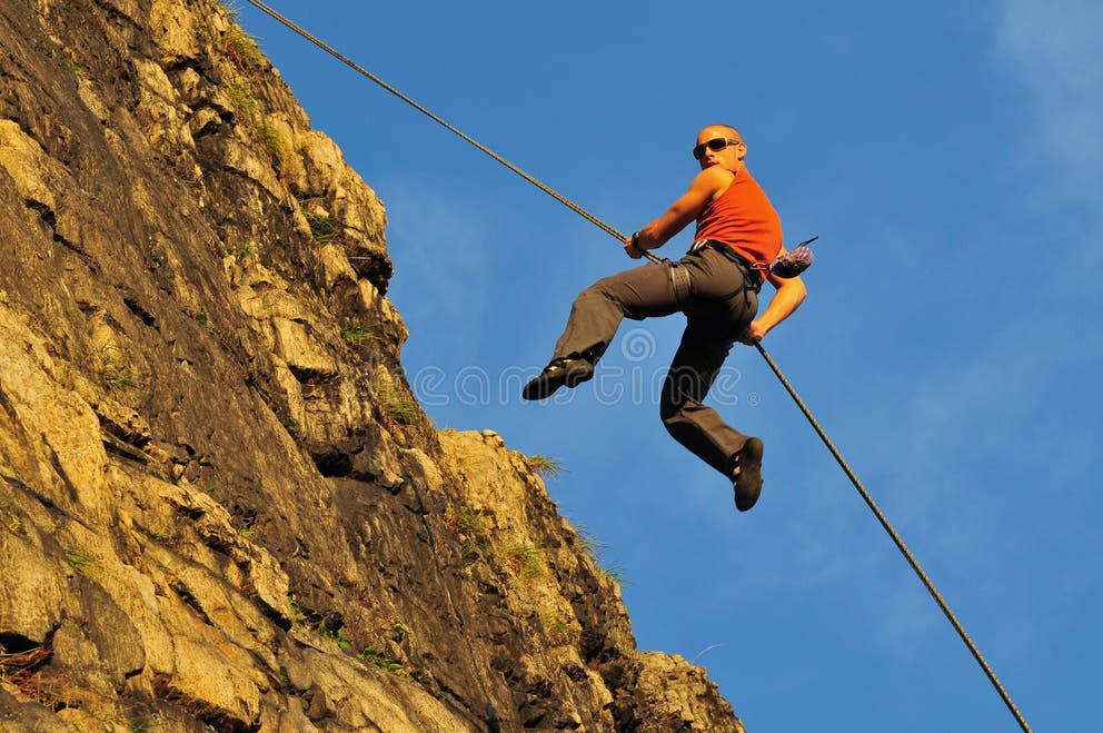 Rock climber jumping stock image. Image of rock, gear - 17605727