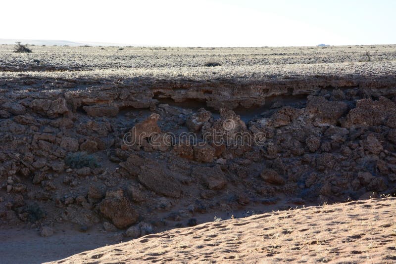 Rock Collapse in the Desert with Stones Falling into the Pit. Profile ...