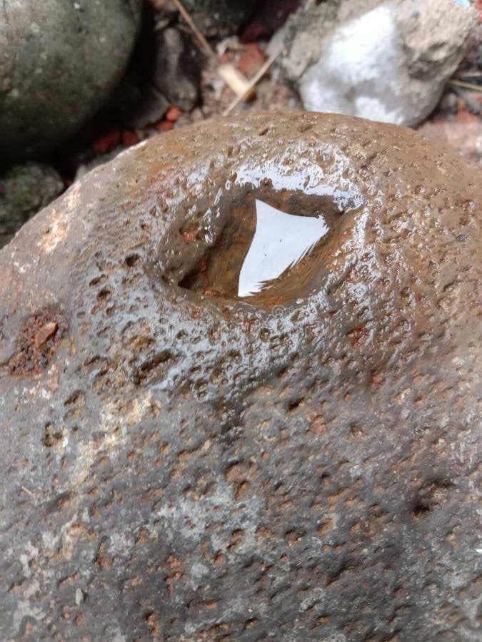 A Rock that is Continuously Perforated by Raindrops Stock Photo - Image ...