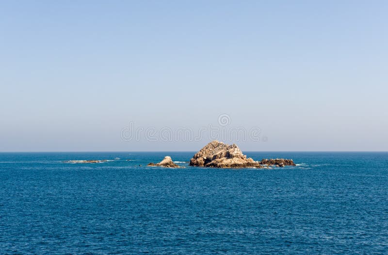 Rock formation in blue sea stock photo. Image of rock - 7312310