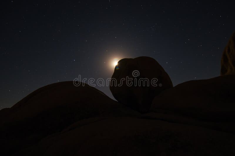 A Rock Formation Eclipses the Moon Stock Image - Image of space, tree ...