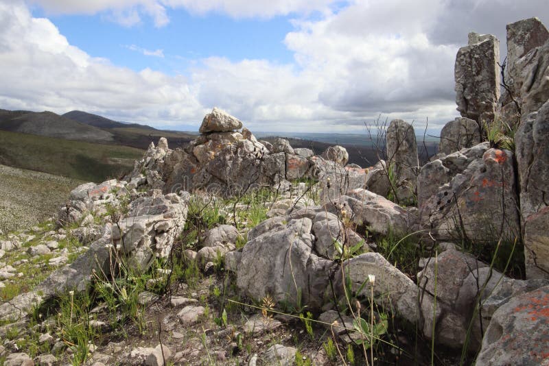 Rock Formation on a Hill with a Distant View Stock Photo - Image of ...