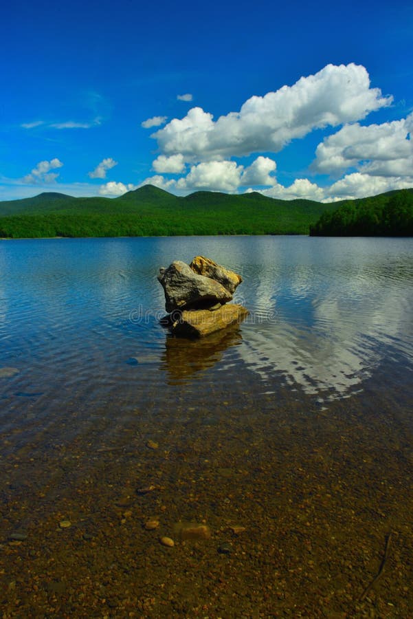 Rock Formation in the Middle of the Clear Lake with a Reflection of the ...