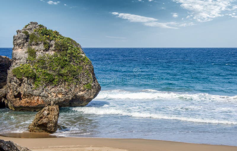 Rock Formation Rising Out of the Sand of a Beach Stock Photo - Image of ...