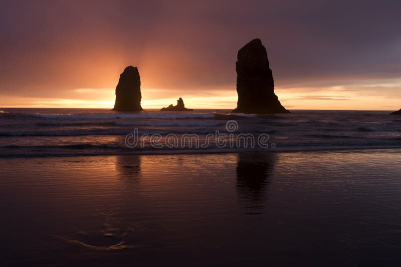 Rock Formation in the Waves at Cannon Beach, Oregon at Sunset Stock ...