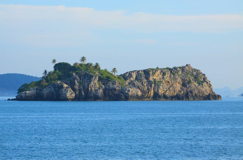 Rock island in deep sea stock image. Image of island - 24389425