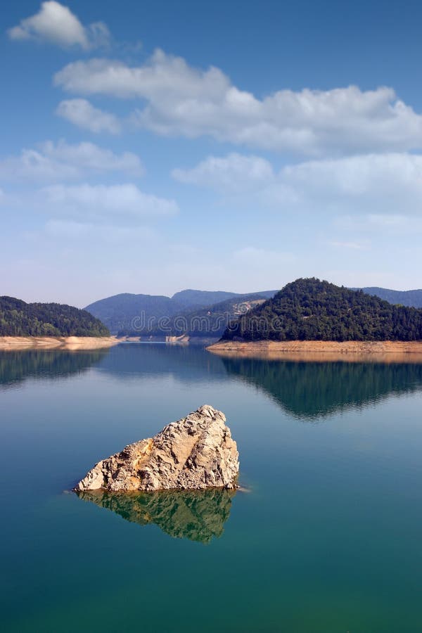 Rock in the lake stock image. Image of hill, morning - 98841435