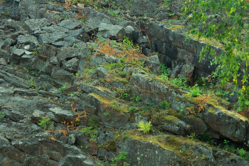 Rock of Layered Stone Overgrown with Grass and Moss. Texture of Stone ...