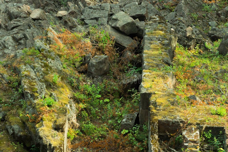 Rock of Layered Stone Overgrown with Grass and Moss. Texture of Stone ...