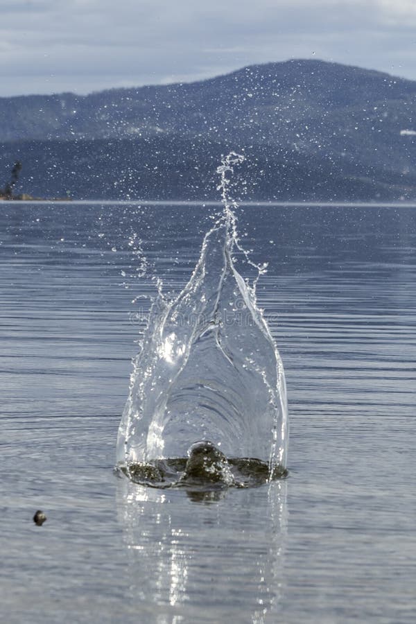 Rock makes a big splash. stock photo. Image of rock, splash - 66868602