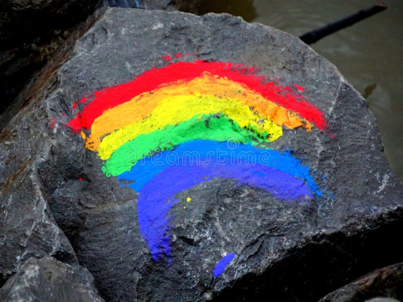A Rock Painted with Rainbow Colors Stock Image - Image of green, yellow ...