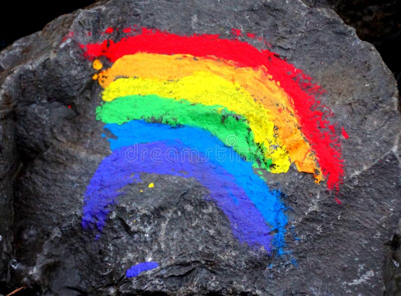 A Rock Painted with Rainbow Colors Stock Photo - Image of blue ...