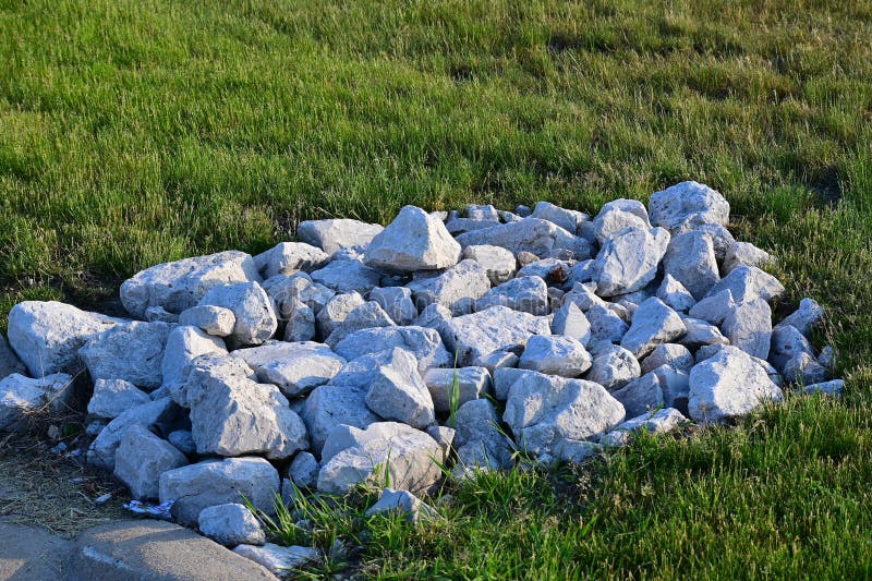 A Pile of Rocks in the Grass Stock Photo - Image of plant, water: 280628568