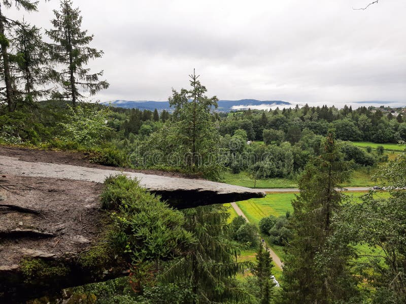 Rock Projection Extending Outwards on Top of a Hill Overlooking Green ...