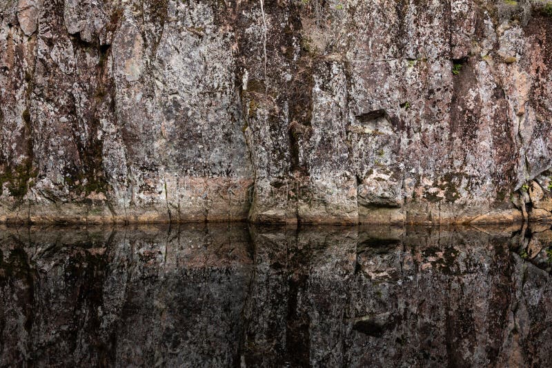 Rock Reflectin To Still Water in Forest Lake Stock Photo - Image of ...