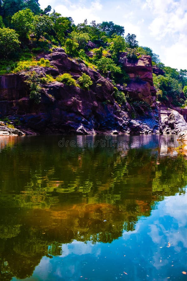 Rock reflection on river stock photo. Image of motion - 193935446