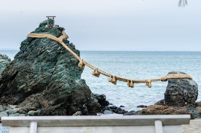 A Rock with a Rope Tied To it is on a Beach Stock Photo - Image of ...