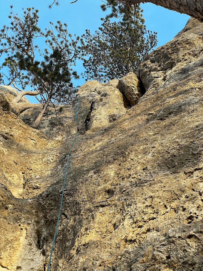 A rock with ropes to climb stock photo. Image of hill - 215165148