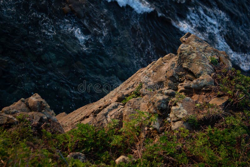 Rock and Sea in Morning Sun Rays Stock Photo - Image of rock, foam ...