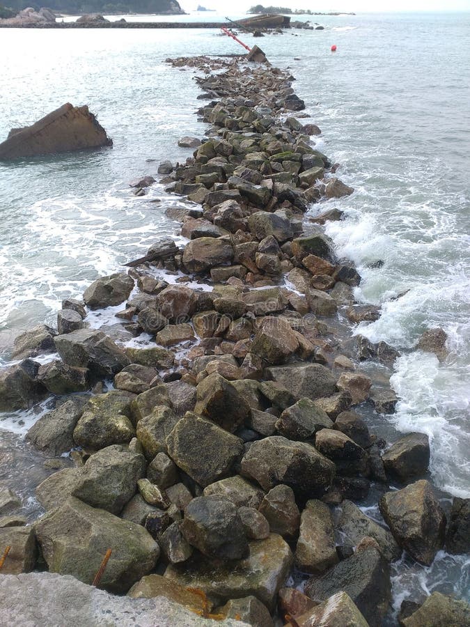 Rock by the sea stock photo. Image of stone, rock, stretched - 211197430