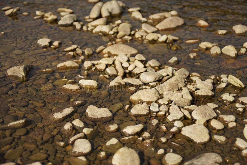 Rock in the shallow water stock photo. Image of stream - 84515194