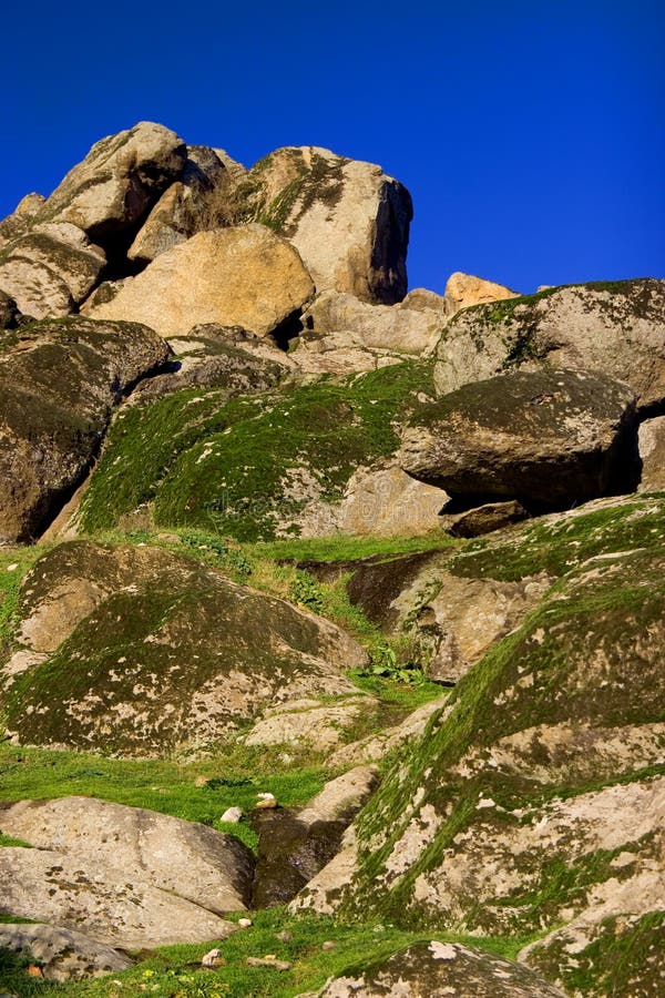 Rock and sky stock photo. Image of texture, green, sunlight - 3730852