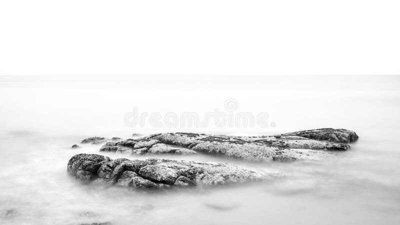 Rock in Smooth Calm Sea stock photo. Image of stone, morning - 95084170