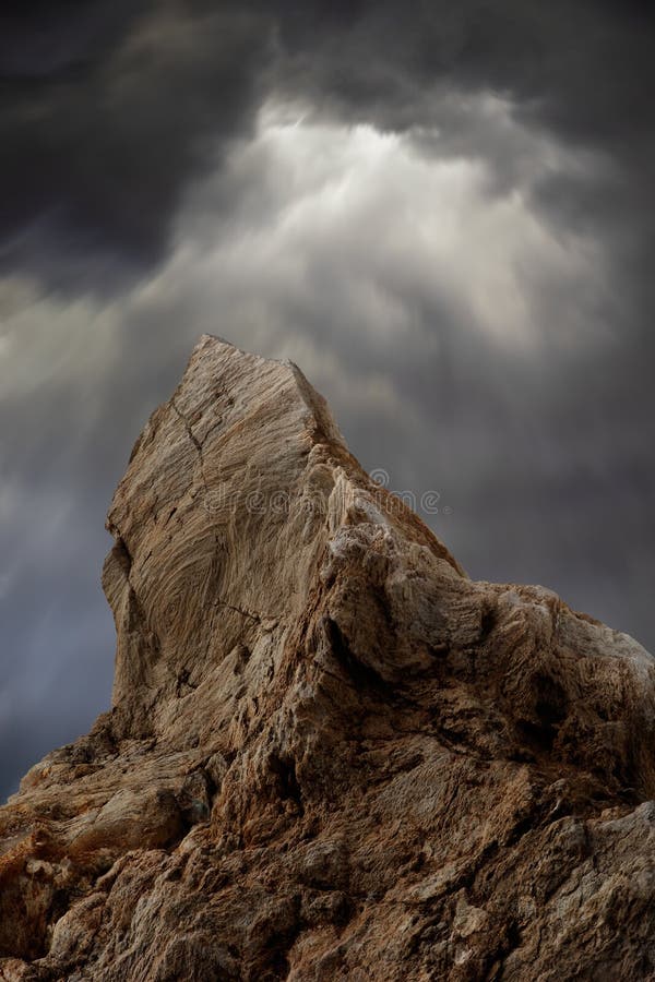 Rock in stormy clouds stock image. Image of cloud, season - 18039813