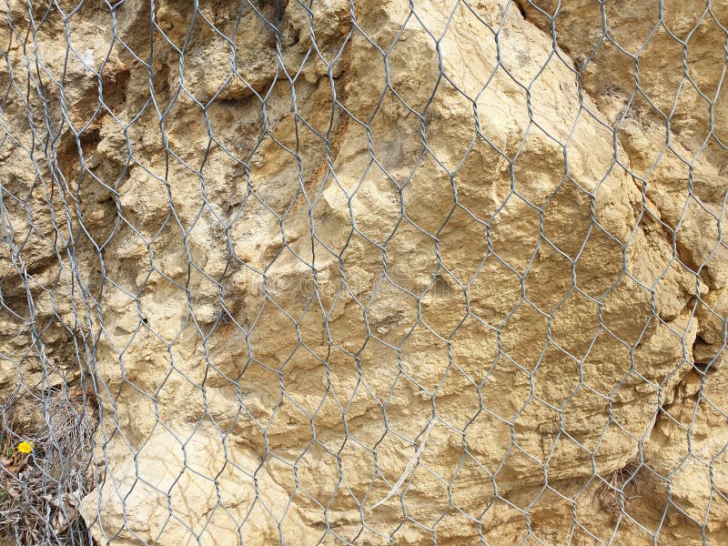 The Rock is Surrounded by a Wire Mesh. Stock Photo - Image of rock ...