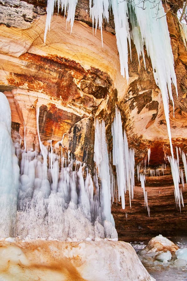 Rock Wall with Icicles and Frozen Ice Formations in Winter Stock Photo ...
