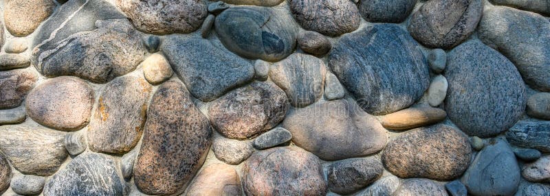 Rock Wall Made of Colorful River Rock, Sun Dappled, As an Abstract ...