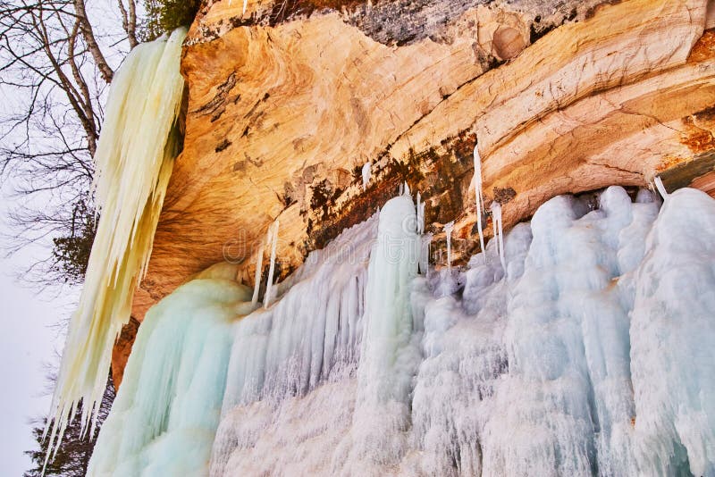 Rock Wall in Winter Covered in Blue Ice Formations Stock Photo - Image ...