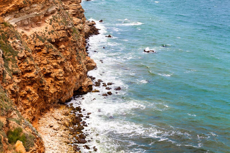 Rock and waves stock photo. Image of cliff, huge, place - 67109396