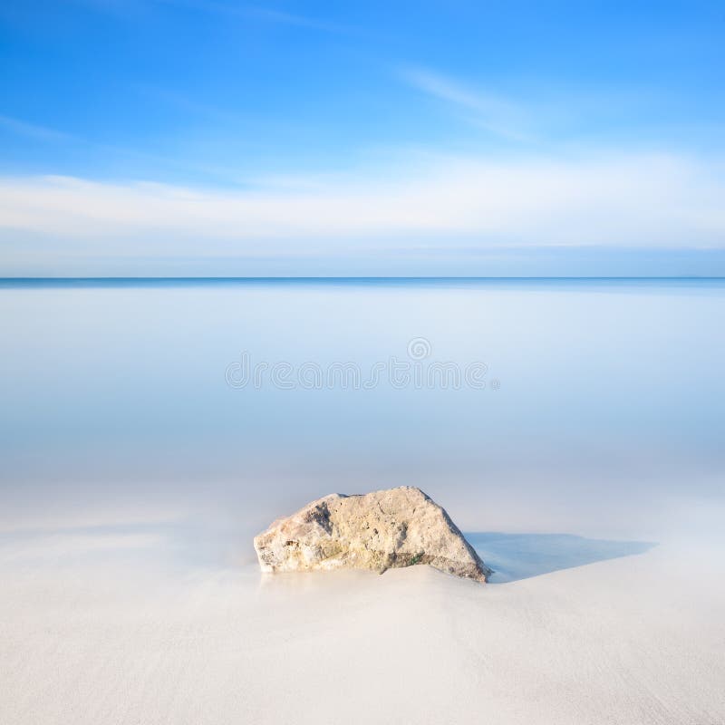White Rock in a White Beach Under Blue Cloudy Sky Stock Photo - Image ...