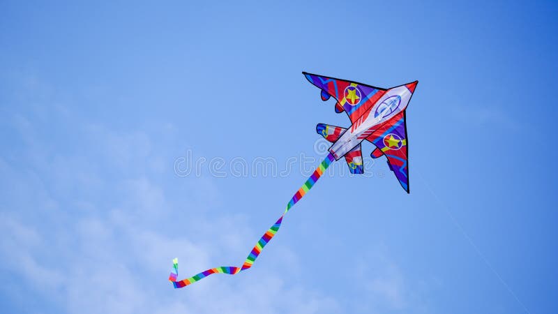 Rocket Shaped Kite Flying High in the Blue Sky Stock Photo - Image of ...