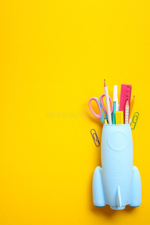 Rocket-shaped Pencil Case with School Supplies on Yellow Background ...
