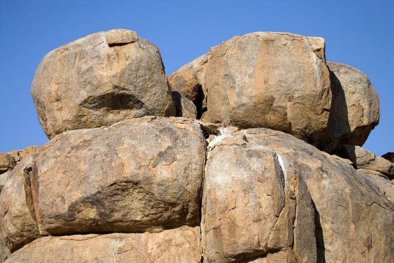 Man Standing on Round Big Rocks on the Edge of a Mountain Stock Image ...