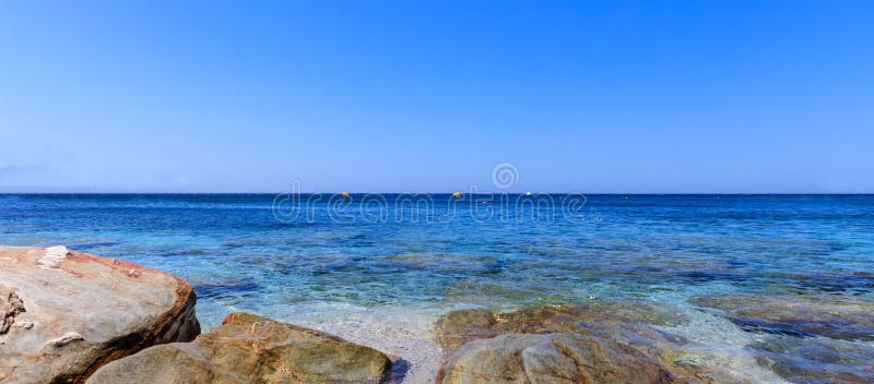 Rocks on a Beach - Blue Sky and Sea Background Stock Image - Image of ...