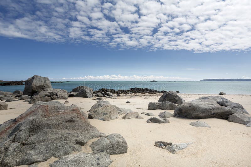 Rocks on the beach stock photo. Image of blue, sunny - 72904174