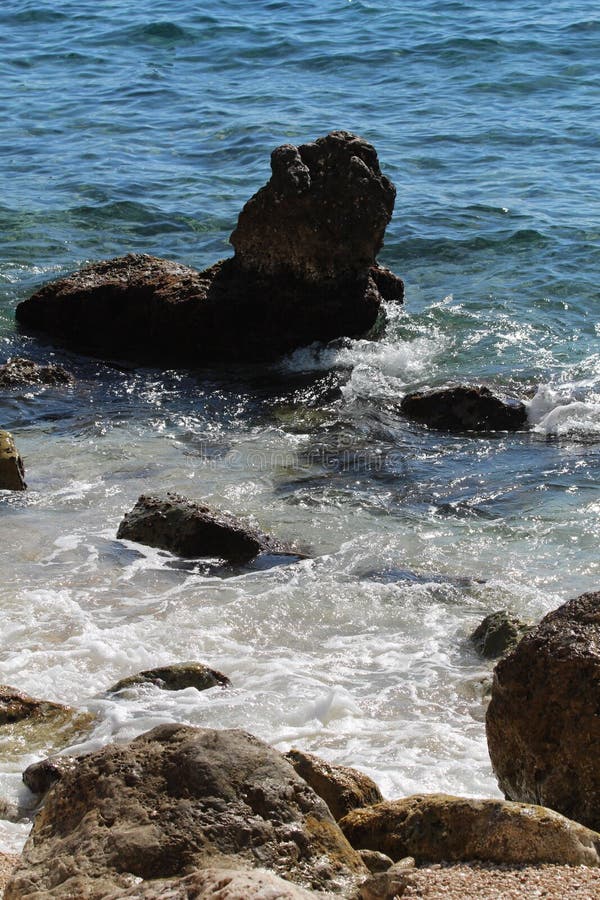 Rocks on the beach stock image. Image of pebble, ocean - 78283551