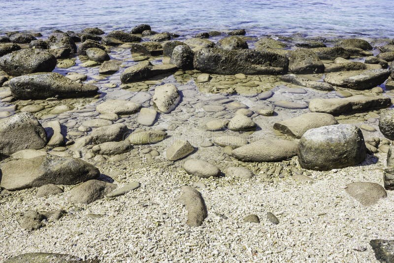 Rocks on the beach stock photo. Image of beach, rocky - 79450172