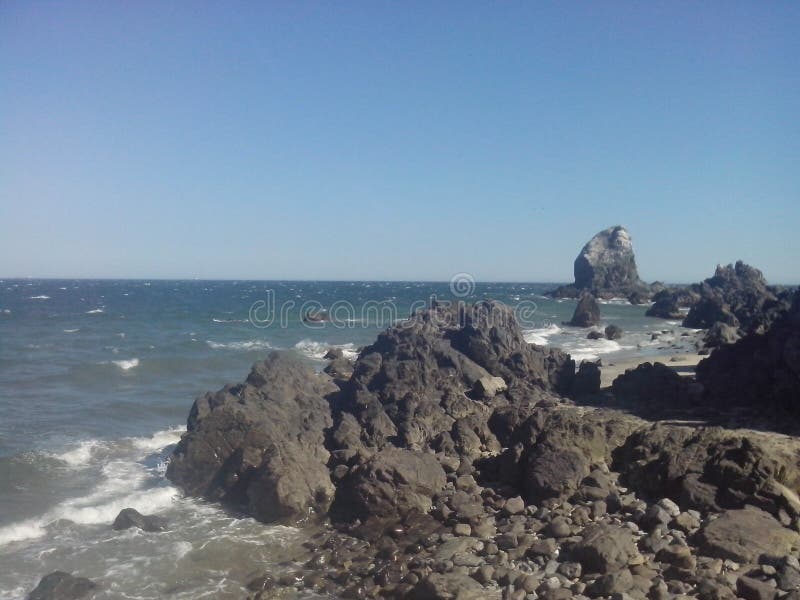 Rocks on the beach stock image. Image of waves, rocks - 151325187