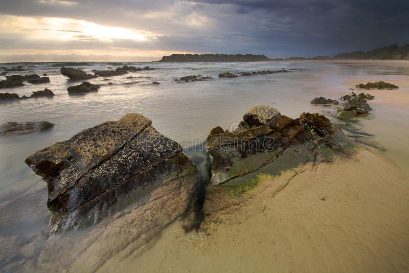 Rocks on the Beach at Sunrise at Evans Head in Australia Stock Image ...