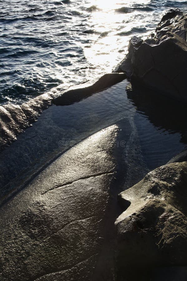 Rocks on Coast with Lapping Water. Stock Image - Image of nature ...