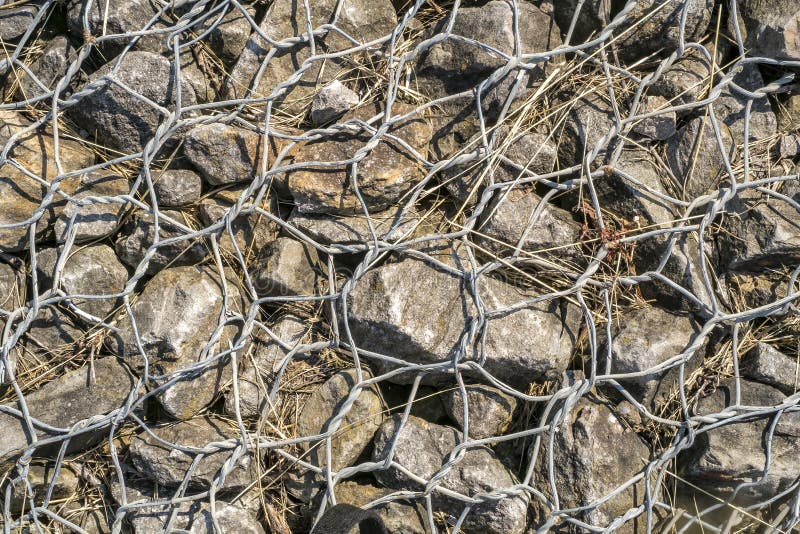 Rocks covered Wire mesh stock photo. Image of view, stones - 96883100