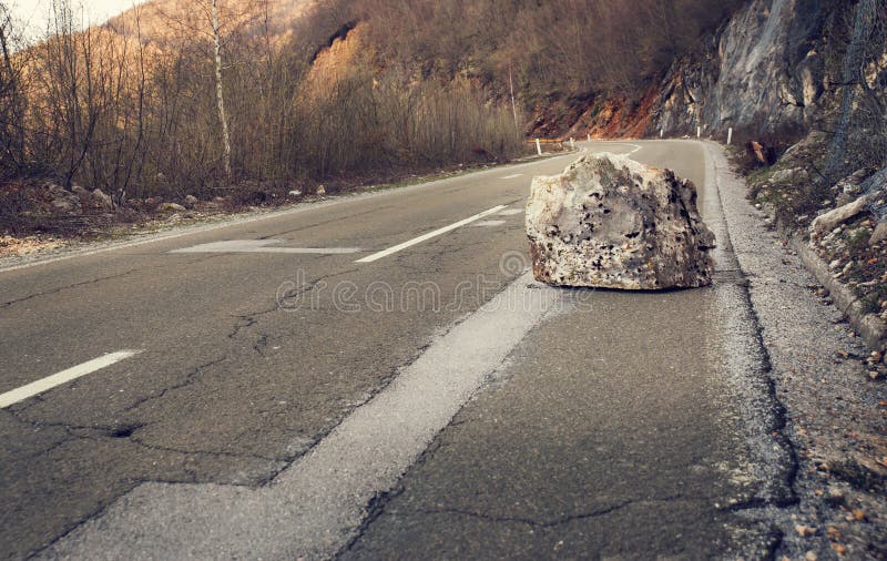 Rocks dropped on the road stock image. Image of mountain - 64594989