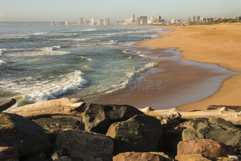 Rocks on Durban Beach with Cityscape in Distance Stock Image - Image of ...