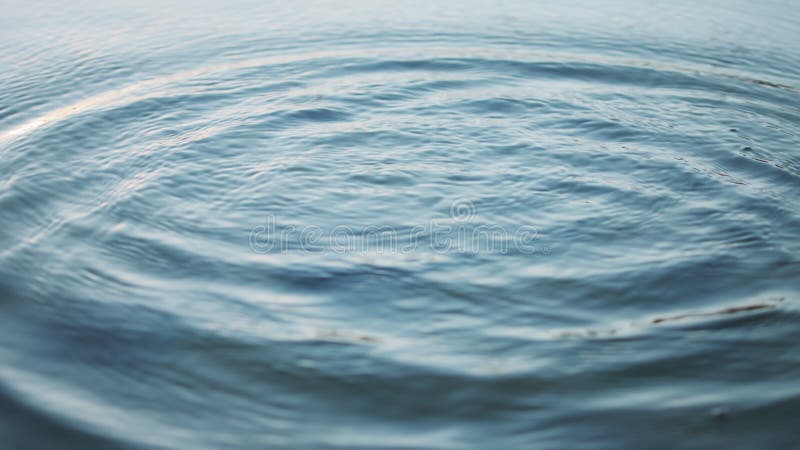 Rocks Falling in the Lake Water Creating Ripples on the Surface Stock ...